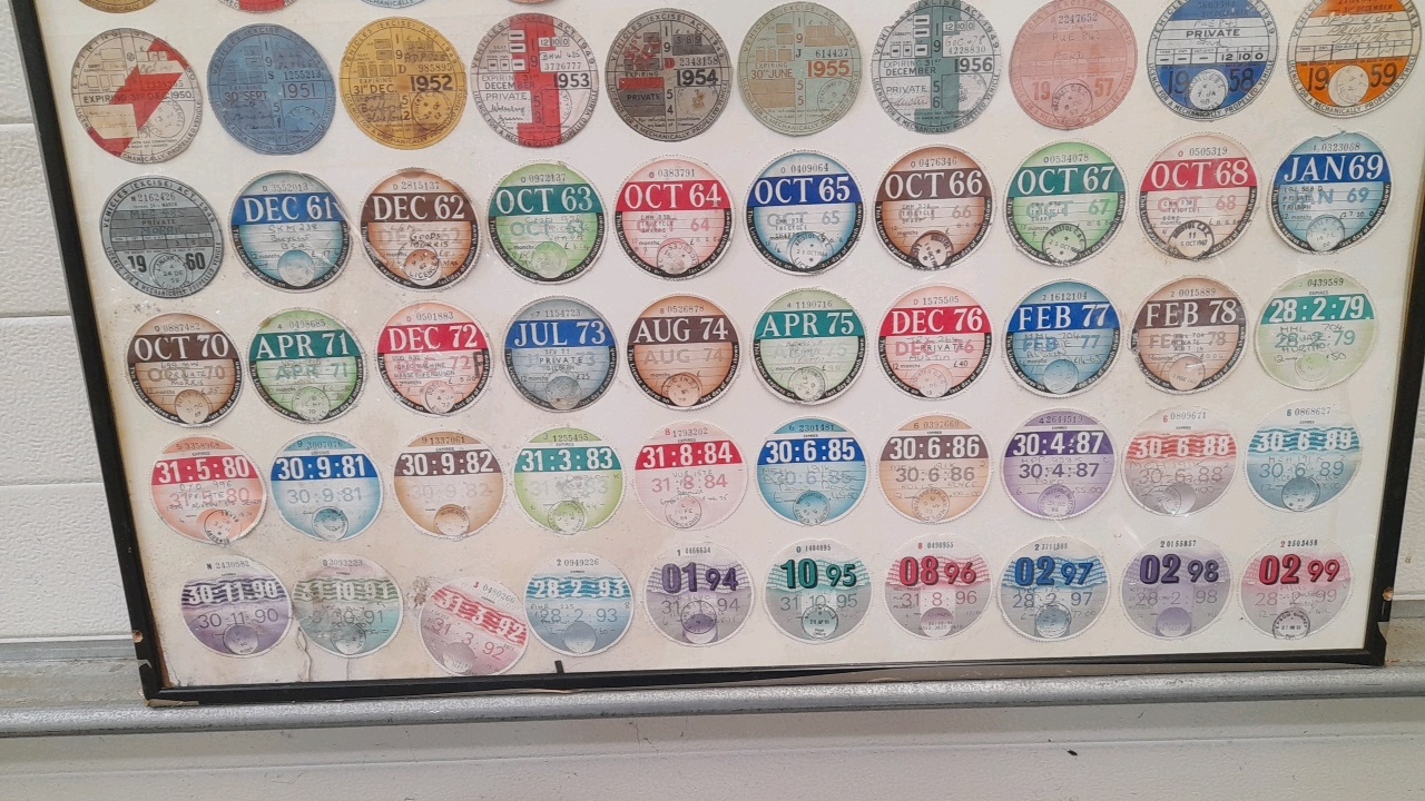 Lot 51 - FRAMED ORIGINAL TAX DISCS FROM 1921-1999