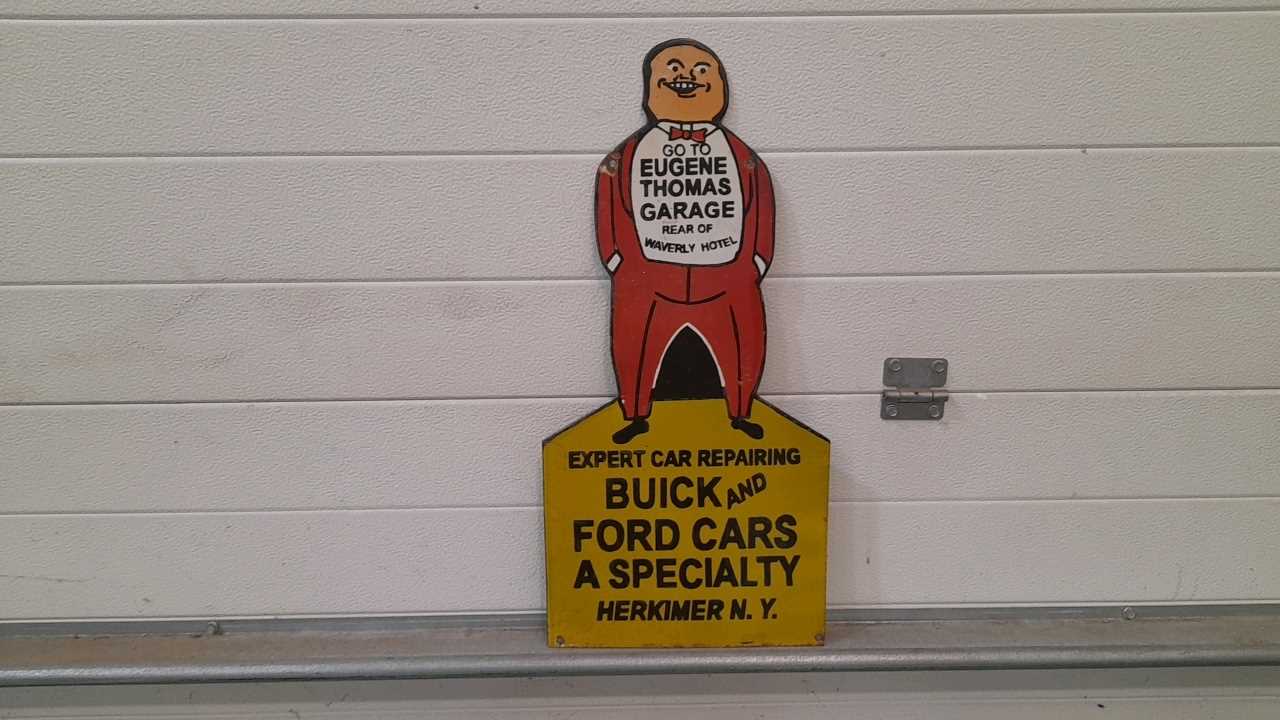 Lot 235 - GO TO EUGENE THOMAS GARAGE ENAMEL SIGN
