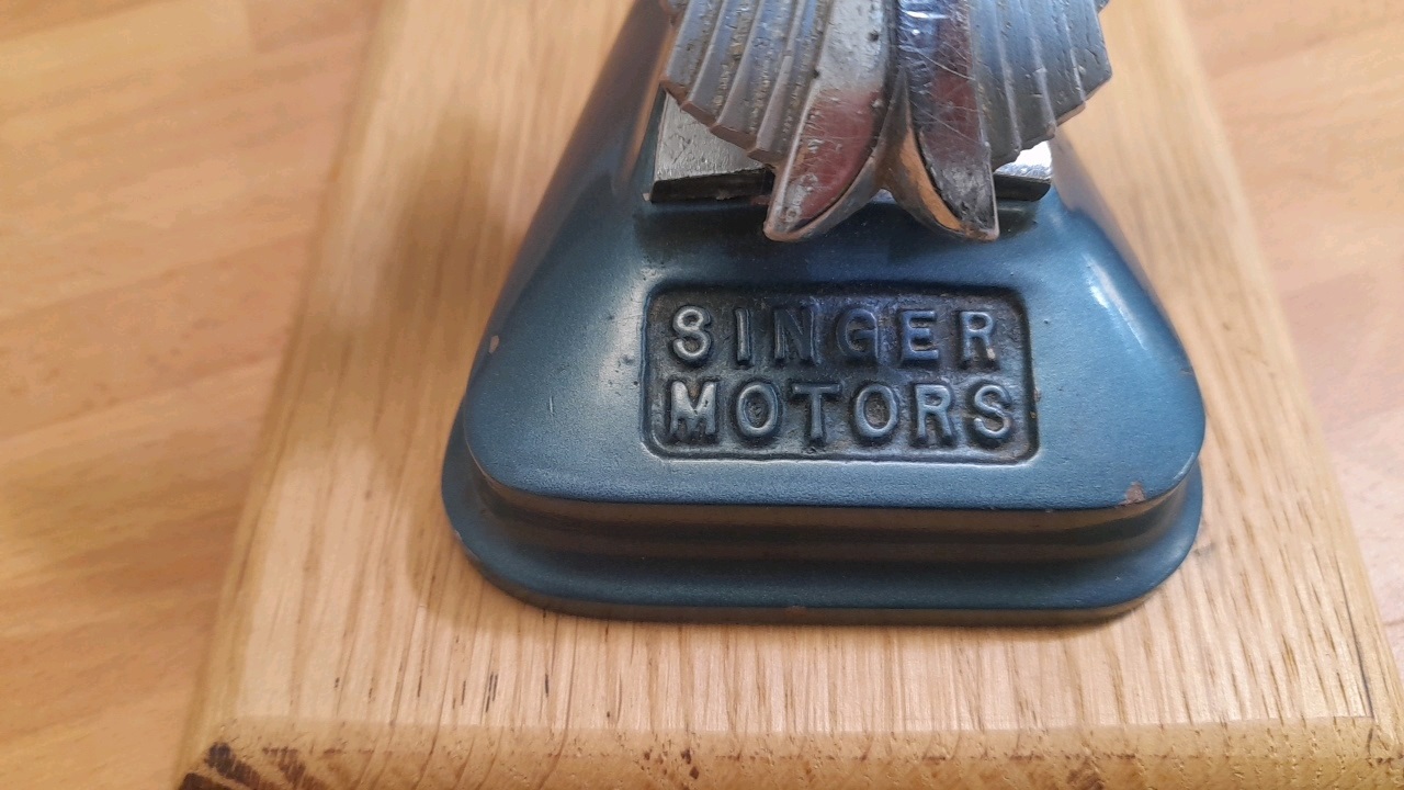 Lot 13 - SINGER MOTORS BONNET MASCOT MOUNTED ON OAK