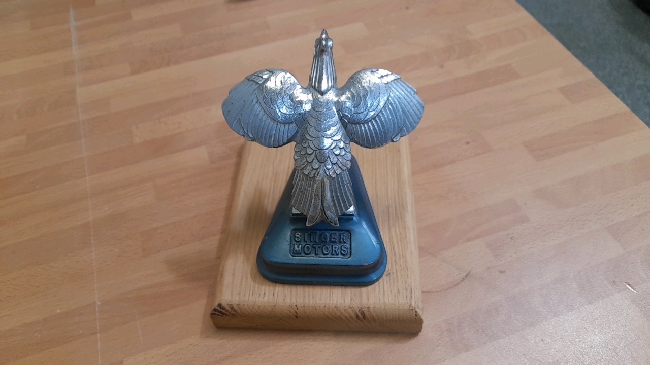 Lot 13 - SINGER MOTORS BONNET MASCOT MOUNTED ON OAK
