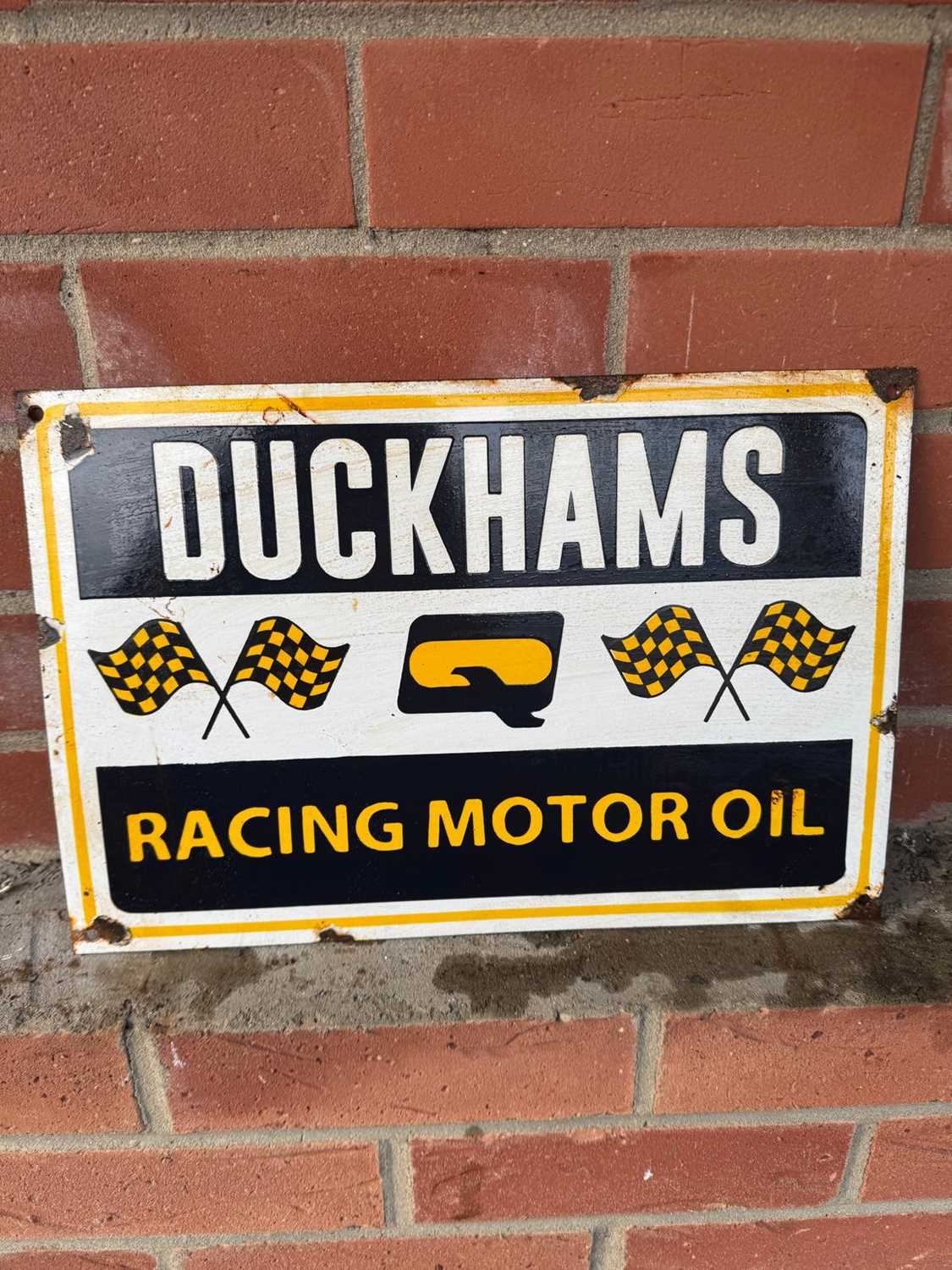 Lot 653 - DUCKHAMS RACING MOTOR OIL ENAMEL SIGN 15" X