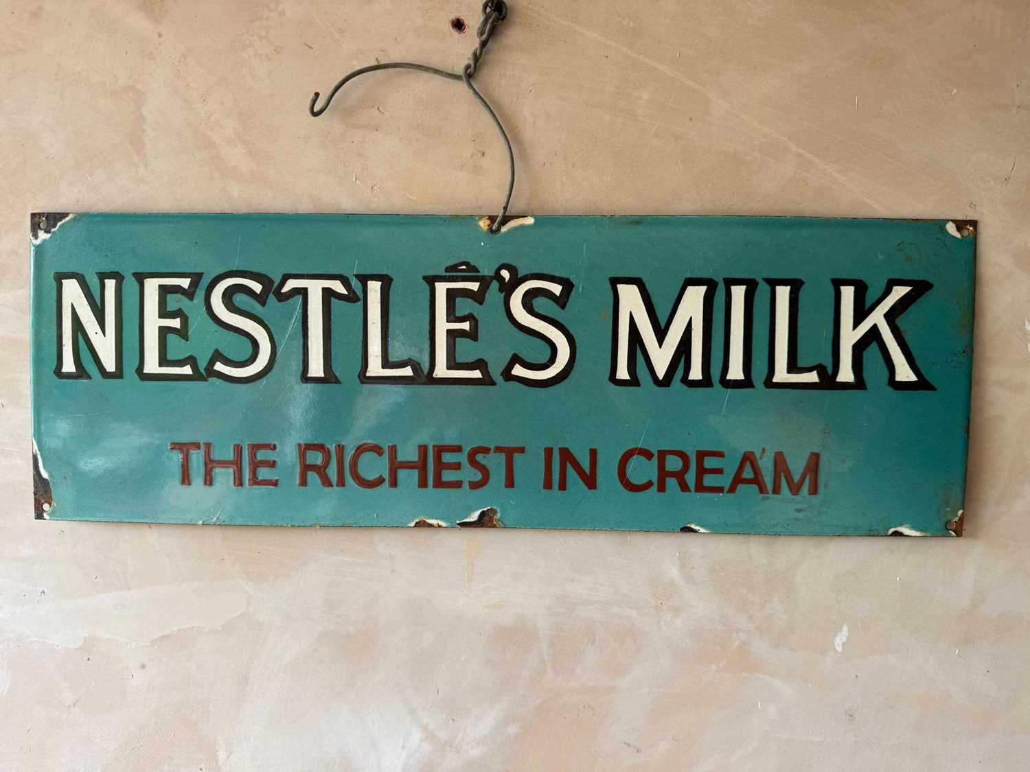 Lot 199 - NESTLE'S MILK ENAMEL SIGN 24" X 8"